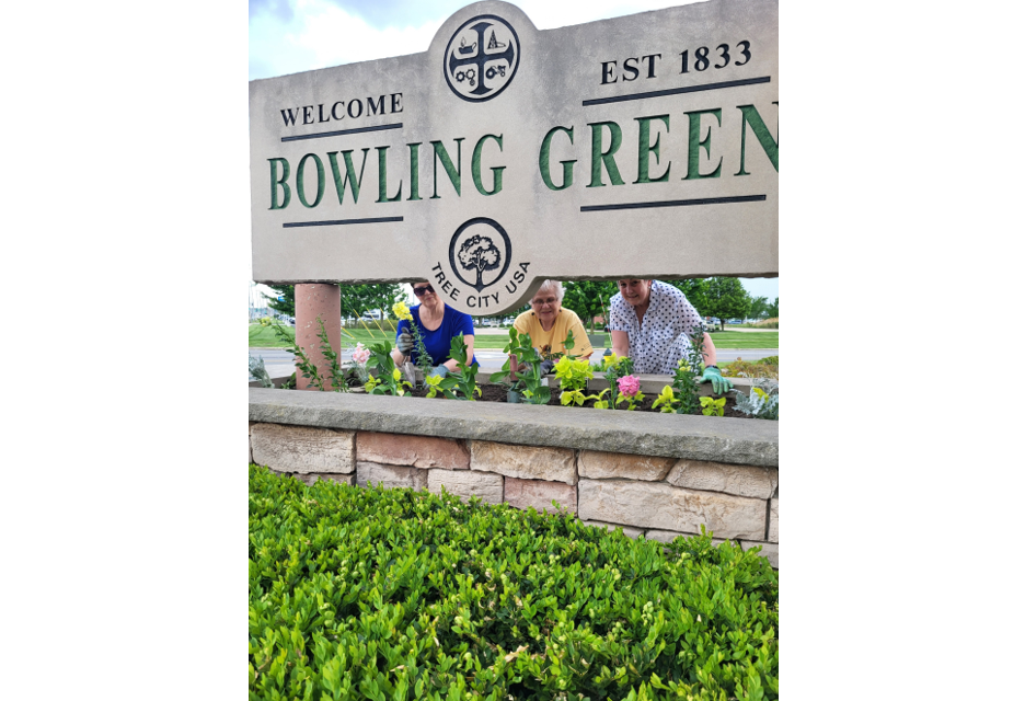 GFWC’s Women’s Club of BG Garden Group plants flowers at ‘Welcome’ sign ...